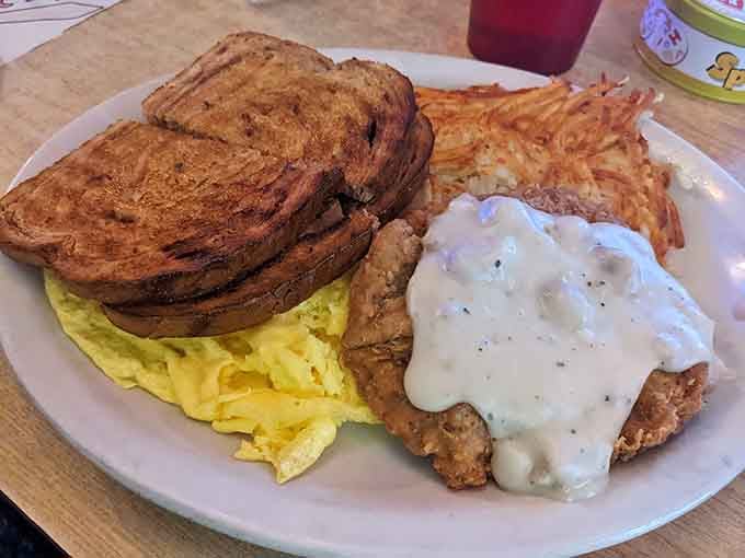 Country fried steak smothered in gravy alongside scrambled eggs&mdash;this plate means serious business about breakfast.