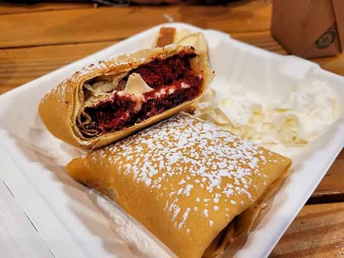 Red velvet crepe burritos dusted with powdered sugar prove that breakfast dessert hybrids are humanity's greatest achievement.