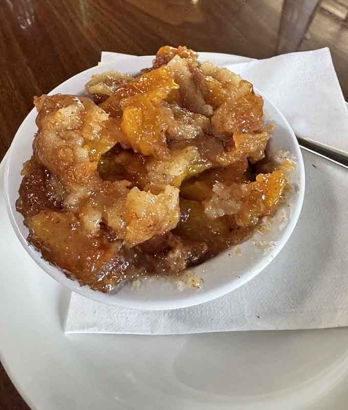 Peach cobbler glistening with buttery goodness, proving that Georgia knows exactly what to do with its famous fruit.