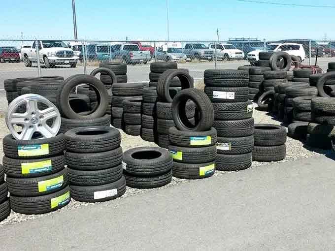 Tires stacked higher than your last car repair bill, ready to keep you rolling without the dealership drama.