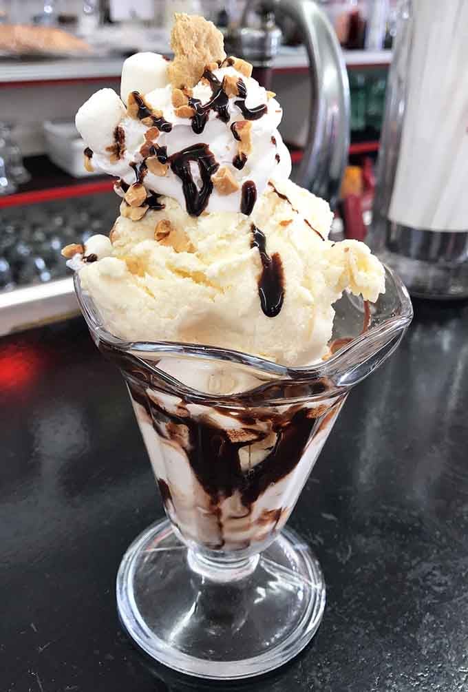 Hot fudge cascading over vanilla ice cream like a delicious avalanche you actually want to be buried under.