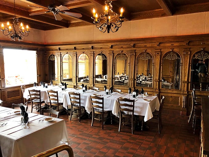 Crisp white tablecloths and ornate mirrors reflect an elegance that makes every meal feel like a special occasion worth celebrating.