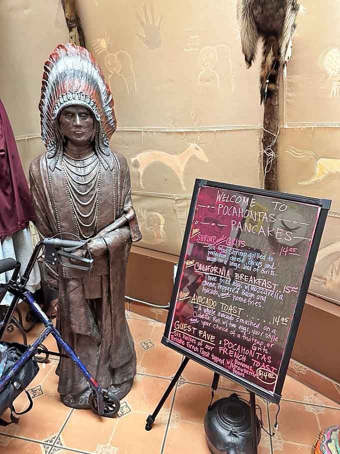 A bronze statue welcomes you with a chalkboard menu, setting the tone for this wonderfully peculiar breakfast adventure ahead.