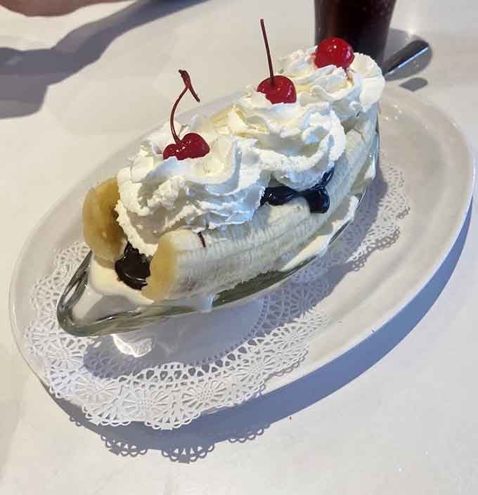The banana split arrives like a monument to excess, crowned with cherries and zero regrets whatsoever.