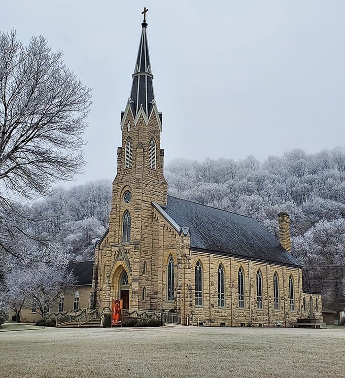 St. Joseph's Catholic Church stands majestically against a frost-kissed winter backdrop, its limestone walls and soaring spire reaching skyward like a prayer made permanent.