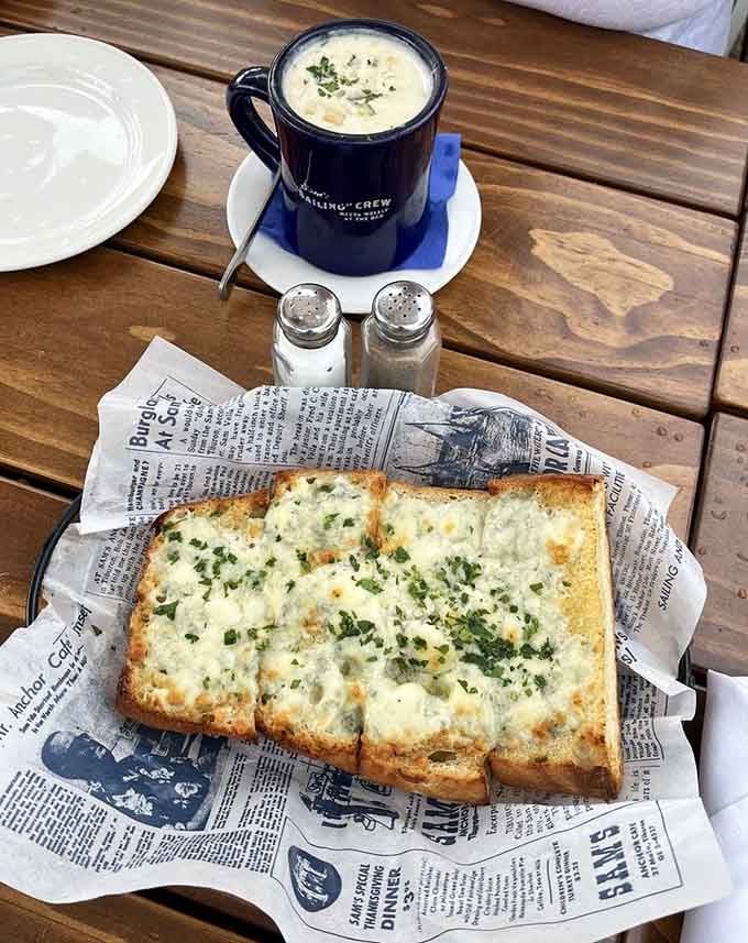 Parmesan garlic bread done right, golden and aromatic, paired with a steaming mug of New England clam chowder for pure comfort.