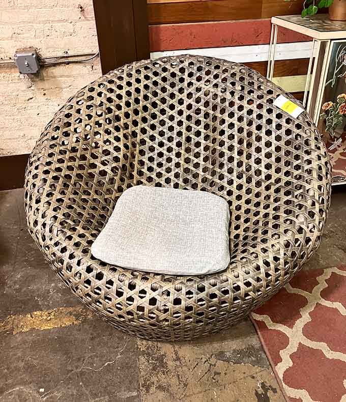 This woven rattan chair looks like it belongs in a 1970s conversation pit, and honestly, that's not a complaint.