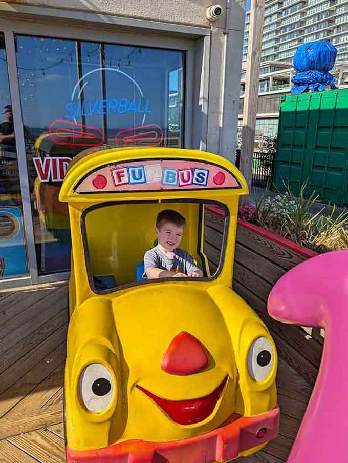 Even the little ones get their moment of joy with this cheerful yellow bus photo opportunity.