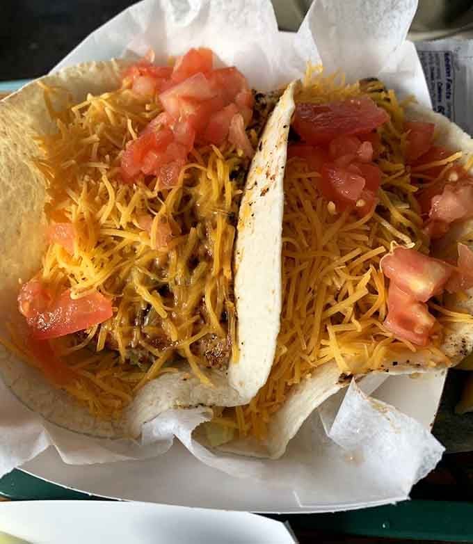 Fish tacos loaded with cheese and fresh toppings, because sometimes handheld is the best way to eat.