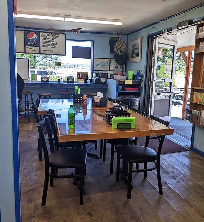 Sunlight streams through windows onto tables ready for the lunch rush, where maritime photos watch over diners like old friends.
