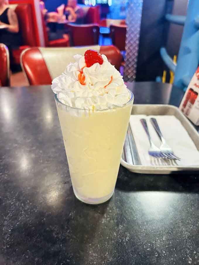This towering milkshake is pure nostalgia in a glass, crowned with whipped cream and cherry.