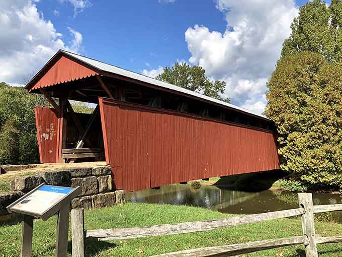 The Staats Mill Covered Bridge stands as a crimson reminder that sometimes the old ways of crossing still make for the best journey.