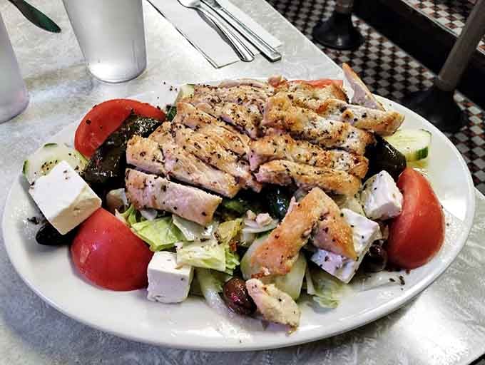Greek salad topped with grilled chicken proves diners can do healthy without sacrificing flavor or portion size.