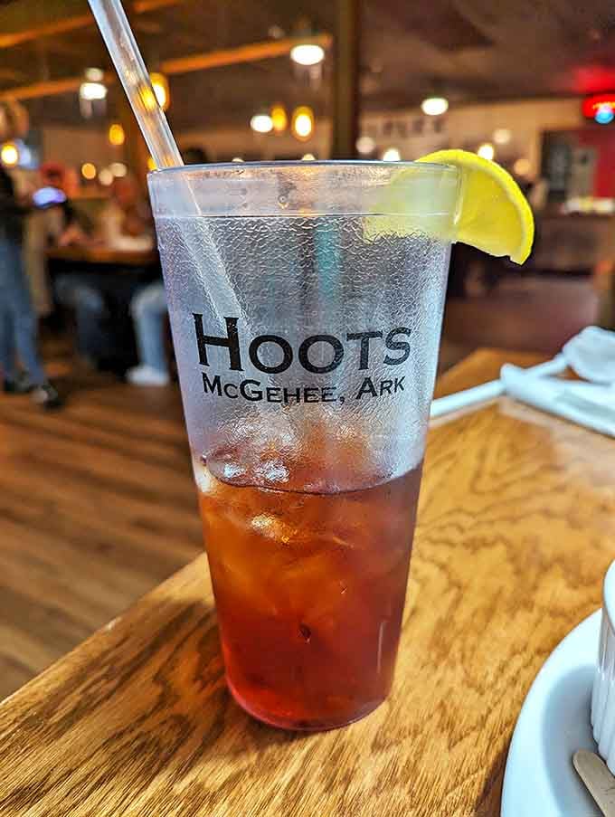 Sweet tea in a glass tall enough to keep you hydrated through three courses of smoked perfection. The lime isn't just garnish&mdash;it's necessary balance.