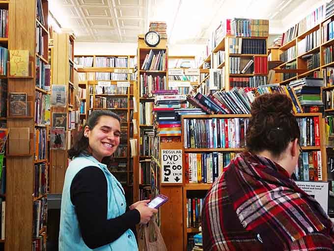 Happy shoppers navigating the maze of shelves, their smiles revealing they've struck literary gold already today.