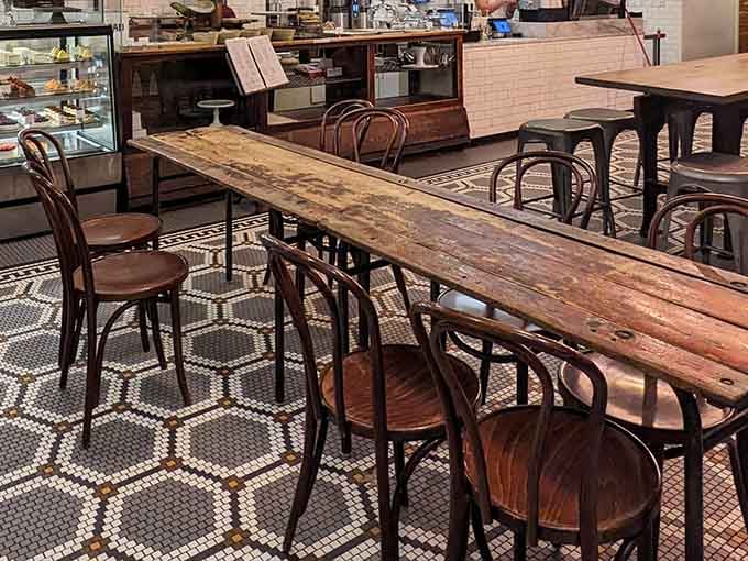 Those communal tables invite strangers to become neighbors, at least for the duration of a latte and pastry.