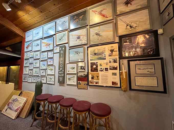 Aviation art fills the waiting area where bar stools invite you to sit and admire the collection before dinner.
