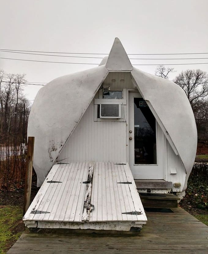 The rear entrance reveals Model T taillights serving as eyes, proving Depression-era ingenuity knew no creative bounds whatsoever.