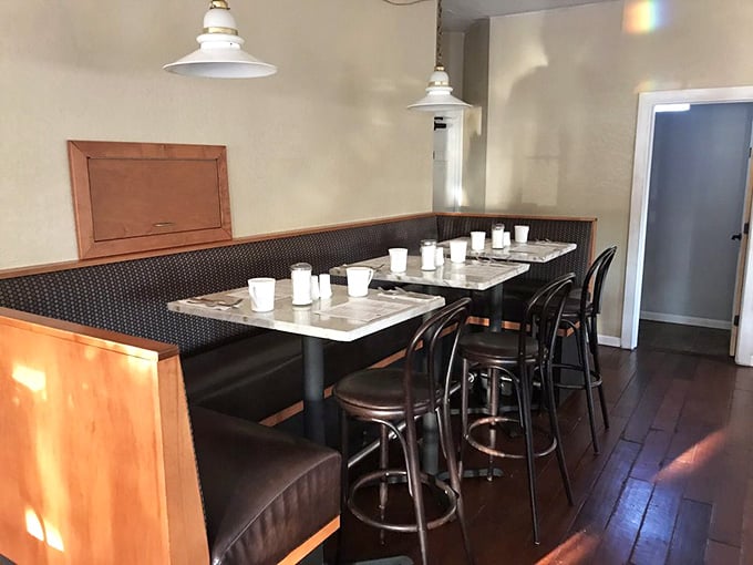 Cozy booths and pendant lighting create that perfect atmosphere where time slows down and breakfast stretches luxuriously.