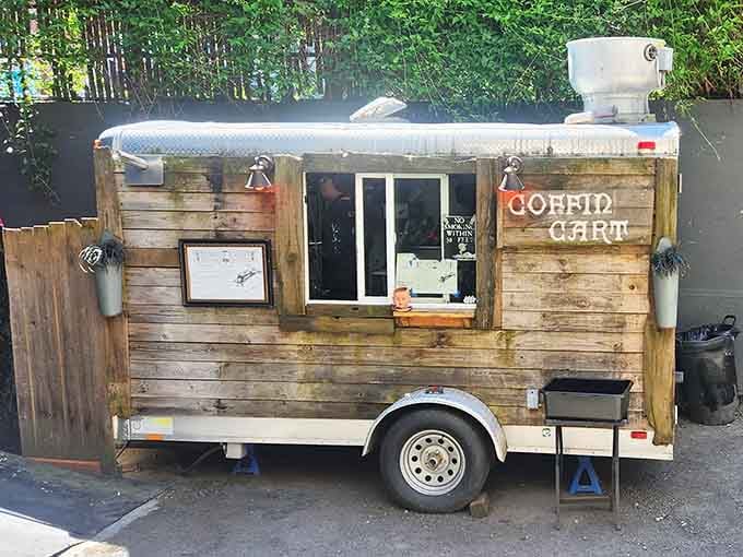 Even the outdoor cart embraces the coffin theme, proving this establishment commits fully to its wonderfully weird aesthetic.