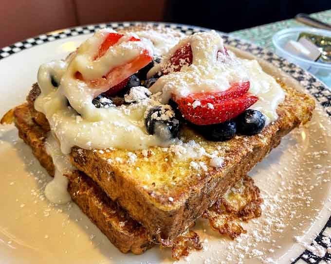 Stuffed French toast topped with berries and powdered sugar, basically dessert disguised as breakfast brilliance.