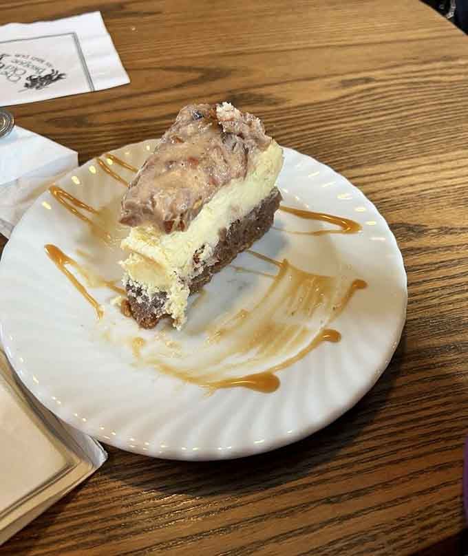 Layered cheesecake drizzled with caramel that makes dessert feel less like indulgence and more like necessity.