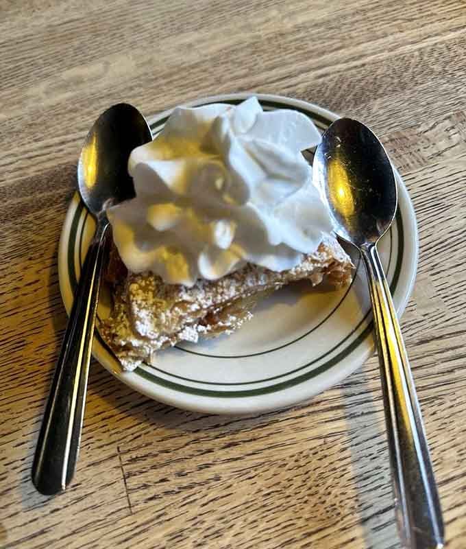 Fresh-baked strudel topped with whipped cream, because sometimes dessert needs its own dessert on top.