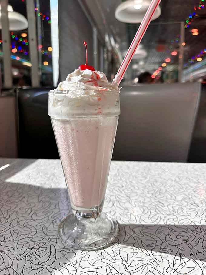 That milkshake is thick enough to require bicep strength, topped with whipped cream and a cherry.