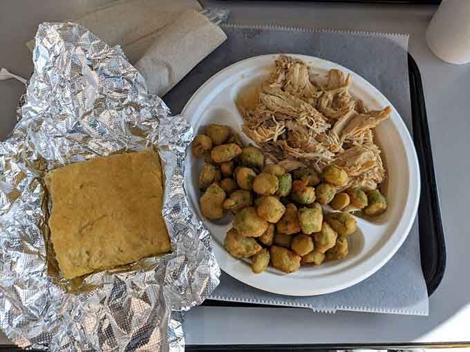 Pulled chicken, fried okra, and cornbread creating a plate that represents everything right about Southern cooking in one glorious arrangement.