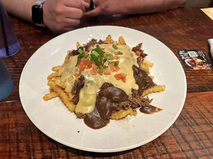 Pot roast poutine smothered in gravy and cheese, because fries deserve this kind of royal treatment.