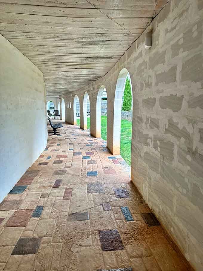 Arched colonnade walkway with brick pavers channels European monastery vibes minus the vow of silence requirement.