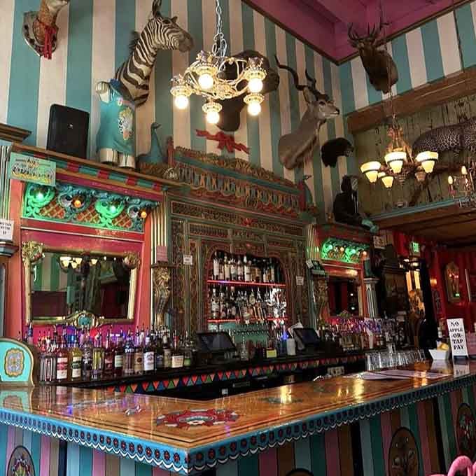 Taxidermy meets neon meets carnival in a bar setup that shouldn't work but absolutely does.