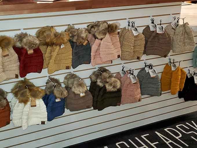 Winter beanies with fur pom-poms that say "I'm cozy and financially responsible" all at the same time.