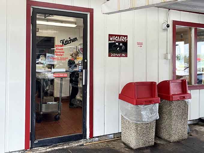 That door leads to happiness, and those vintage trash cans have more character than most modern restaurants combined.
