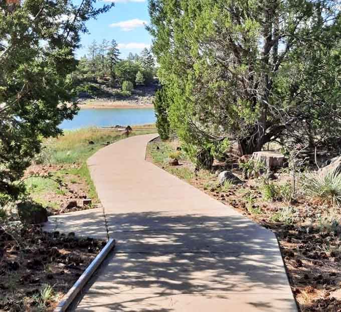 Nature's red carpet: a smooth pathway invites leisurely strolls to the water's edge, no hiking boots required for this accessible slice of wilderness.