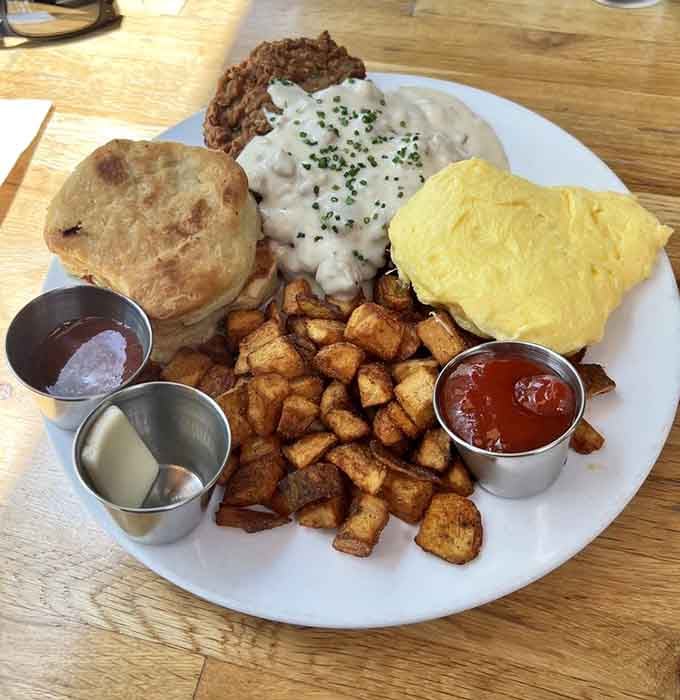 Chicken fried steak with biscuits, gravy, and hash browns is breakfast taken to its logical, delicious conclusion.