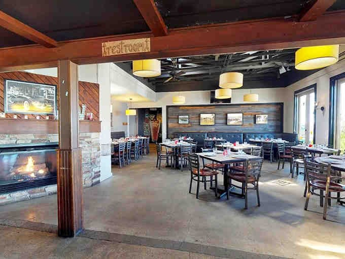 Spacious dining room with exposed beams and a fireplace that whispers "stay awhile" without saying a word.