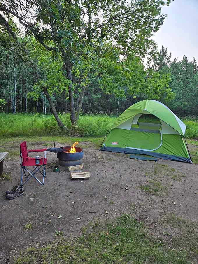 Campsite setup complete with fire ring, because s'mores taste better when surrounded by actual nature.