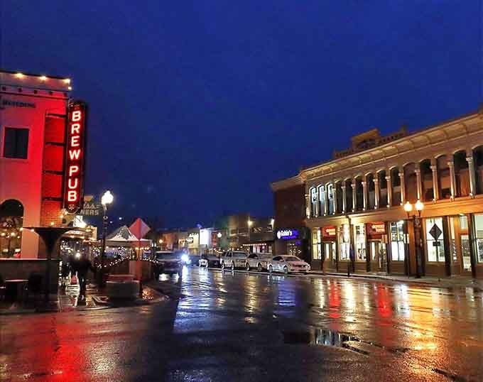Downtown Alamosa glows at night with the Brew Pub sign leading the way to local flavor and community gathering.