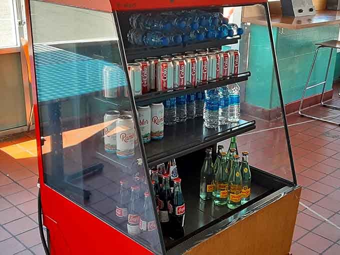 A vintage-style beverage cooler stocked with cold drinks adds to the nostalgic charm of this spot.