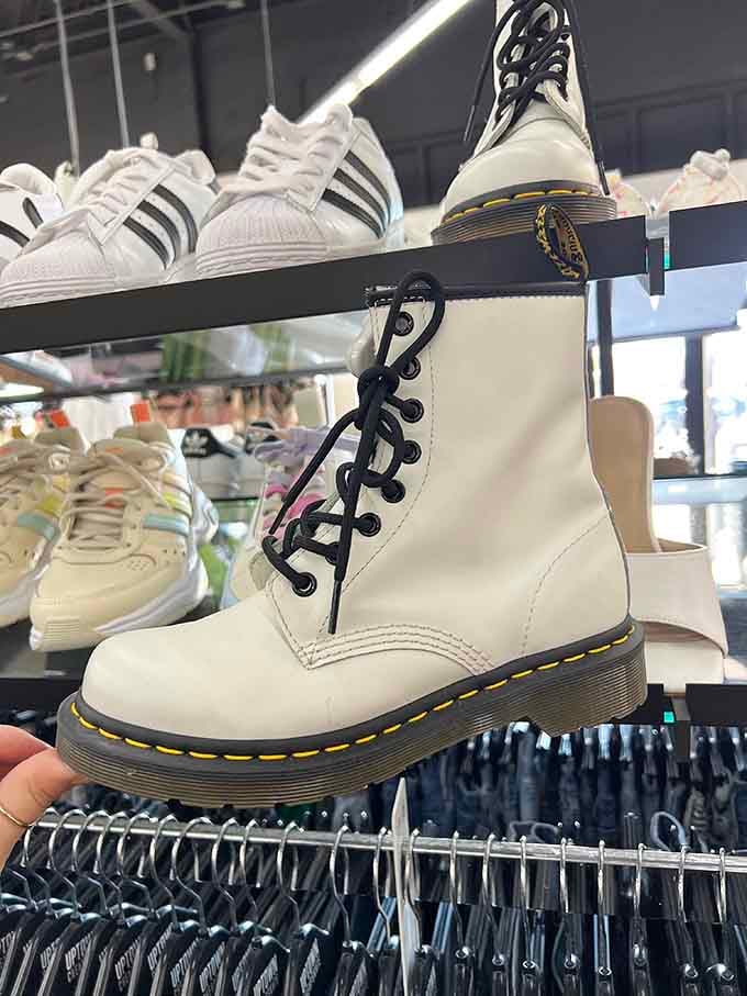 White Doc Martens standing tall among sneakers&mdash;like that one friend who's always slightly overdressed but somehow makes it work perfectly.