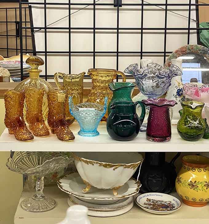 Colored glass catches light like liquid jewels. Amber, emerald, and sapphire vessels that once poured everyday drinks now pour pure nostalgia instead.