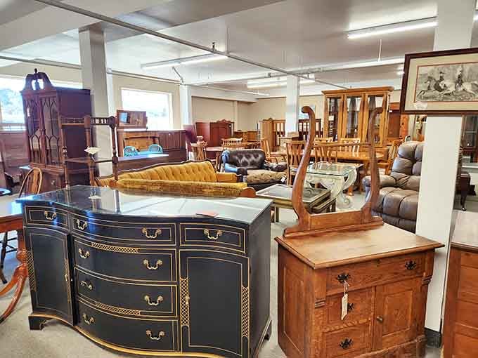 Furniture showroom that spans centuries—that black and gold dresser looks like it belonged in a mansion where people said things like "splendid" unironically.