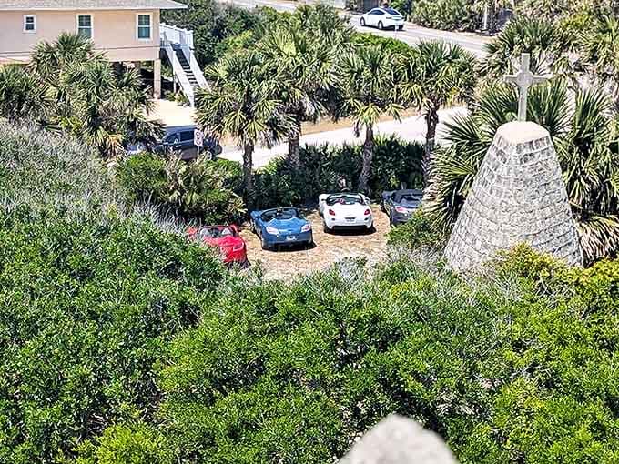 Even knights need parking&mdash;modern chariots rest beneath palm trees, the humble lot a reminder you're still in Florida despite the medieval mirage ahead.