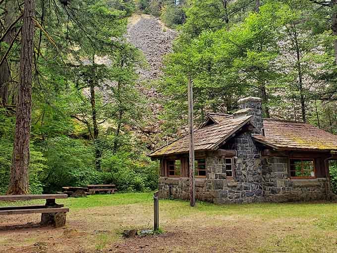 This charming stone cabin nestled among towering pines looks like it's waiting for Goldilocks to declare it "just right."