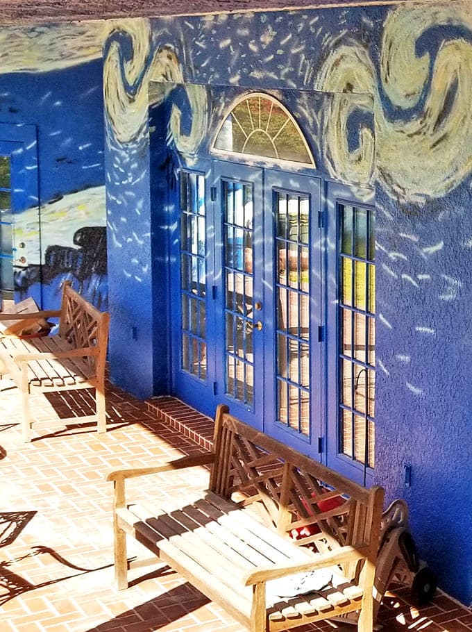 A peaceful sitting area where the painted swirls continue right across the French doors. Imagine sipping morning coffee while literally surrounded by artistic genius!