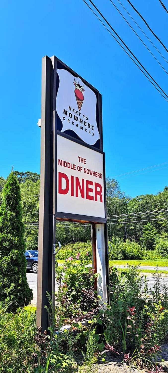 The roadside sign featuring an ice cream cone with a cow face proves that even in the middle of nowhere, there's room for whimsy.