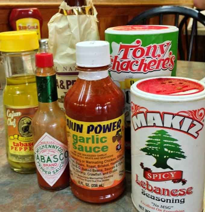 Every table holds the essential Louisiana flavor arsenal: Tabasco, Cajun Power, and Tony Chachere's&mdash;weapons of mass deliciousness.