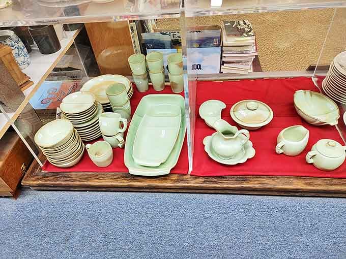 Mint green vintage dinnerware arranged on crimson velvet&mdash;the kind that makes you wonder if meatloaf would actually taste better served on such elegant simplicity.