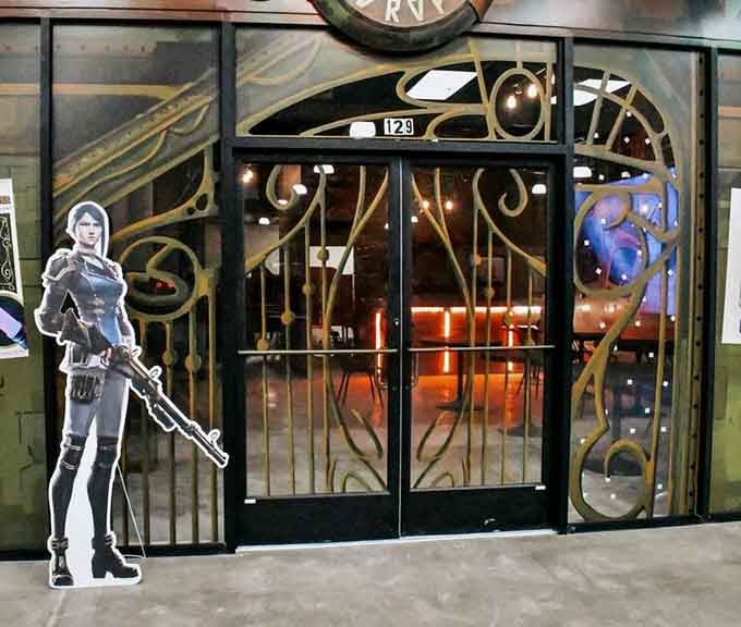 Steampunk-style gates adorned with a warrior cutout guard this gaming paradise where nostalgia meets modern entertainment perfectly.